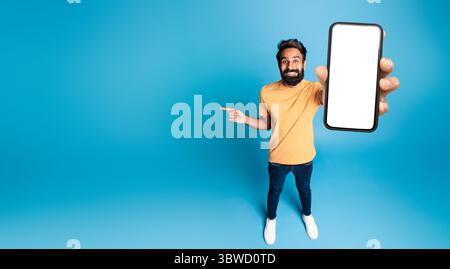 Man Pointing Finger Aside At Huge Phone Screen, Yellow Background Stock ...