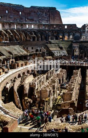 A crowd of people visiting the interior of the great Roman Colosseum ...