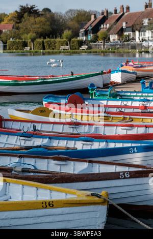 Colourful rowing boats on the Meare boating pond, Thorpeness, Suffolk ...