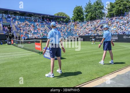 Lexus Eastbourne Open tennis 2025. Ball boy shading a player with an ...