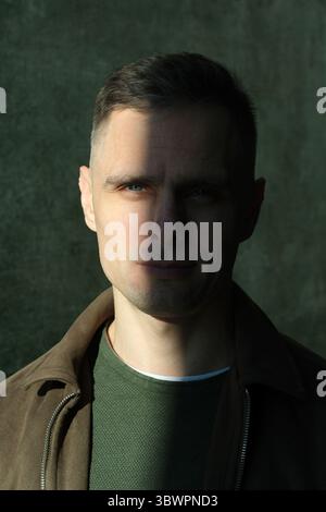 Dark half silhouette portrait with shadows of an angry girl looking up ...