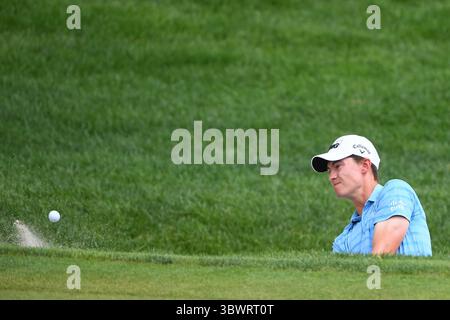 Maverick McNealy hits out of a bunker to the 17th green during the ...