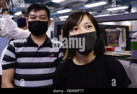 FILE - Chan Pui-man, associate publisher of Apple Daily newspaper walks ...
