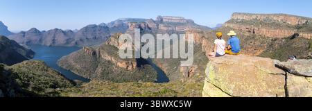 Two hikers enjoying panorama, Blyde River Canyon with Three Rondawels ...