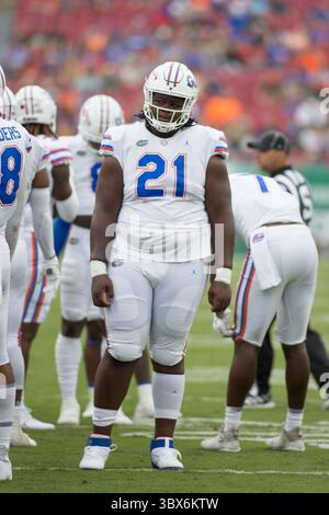 Florida defensive lineman Desmond Watson (21) stiff arms South Carolina ...