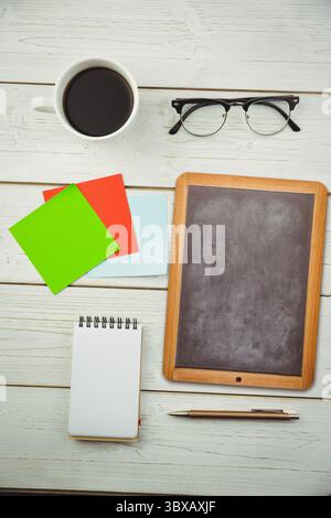 Cup of coffee, blank sticky notes, notebook, keyboard and stationery on ...