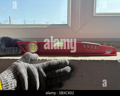 worker checks the level of a window Stock Photo - Alamy