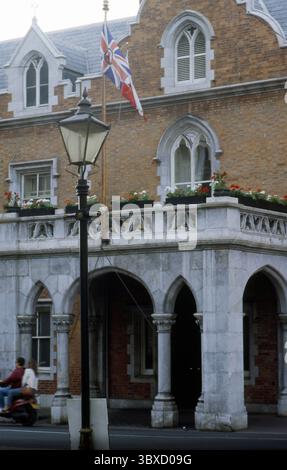 A vertical shot of the Union Jack waving in the air on the top of an ...