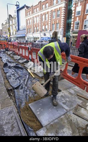 Digging up the pavement in Camden, central London Stock Photo - Alamy