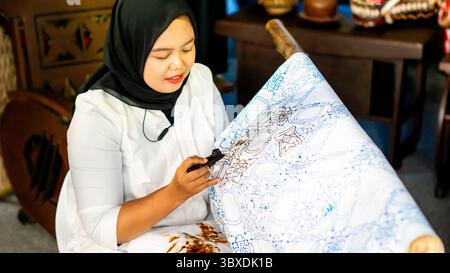The process of making batik cloth. Batik is a type of cloth whose ...