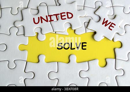 United We Solve text on missing jigsaw puzzle representing teamwork and ...