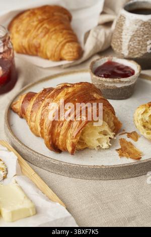 Plate with two fresh croissants and jam on white wooden table Stock ...