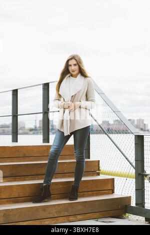 wooden pier on the river bank. Ripple on the water surface. Blurred ...