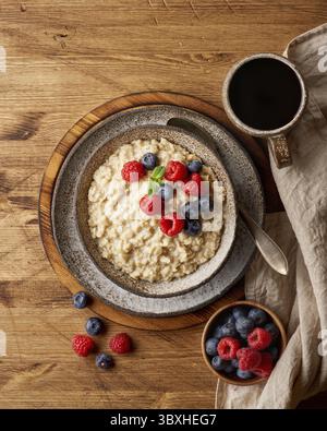 Oatmeal porridge rustic with berries, dash diet, on white wooden ...