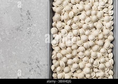 Food, Frozen raw mini dumplings on a gray background. For texture or ...