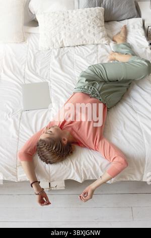 woman with laptop lies on bed internet communication freelance Stock ...