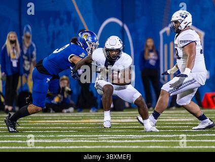Utah State running back Calvin Tyler Jr. (4) gets past Hawaii defensive ...