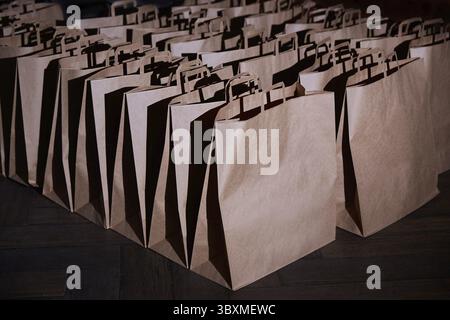 Craft paper bags. The concept of delivering goods or food from stores ...