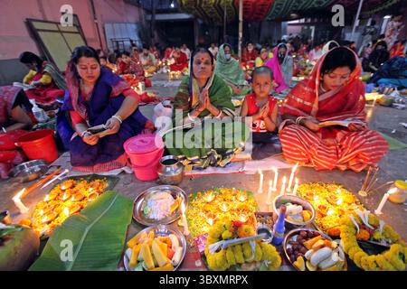 November 16, 2021, Dhaka, Bangladesh: Hindu devotees sit with oil lamps ...