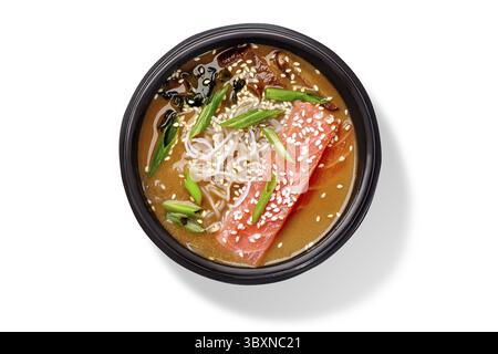 Miso soup with salmon, seaweed and onions, on a black background Stock ...