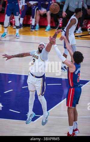 Detroit Pistons' Cade Cunningham, center, goes up for a shot against ...