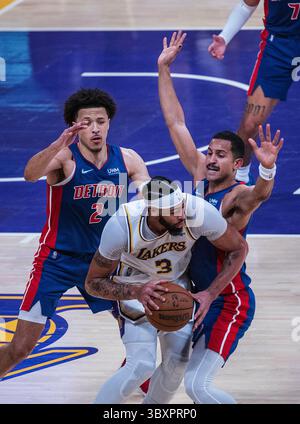 Detroit Pistons' Cade Cunningham, center, goes up for a shot between ...