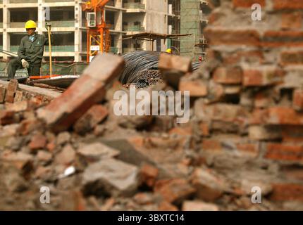 A construction worker surveys the demolition of an old Chinese ...