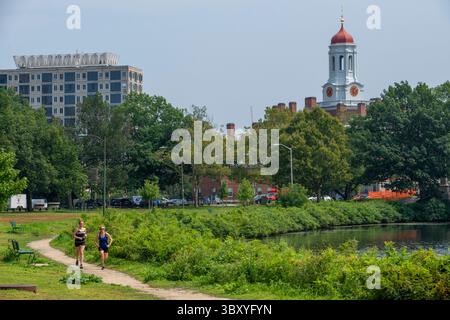 Running in John W. Weeks Bridge and clock tower over Charles River in ...