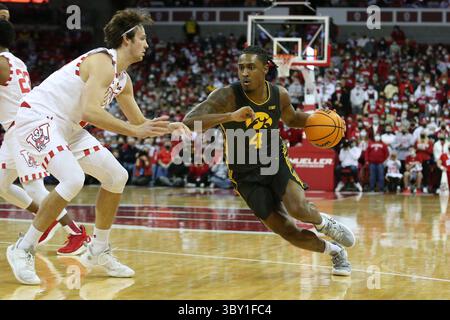 Iowa guard Ahron Ulis, center, stretches during practice after Iowa's ...