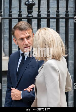 President Emmanuel Macron and wife Brigitte Macron, both wearing a mask ...