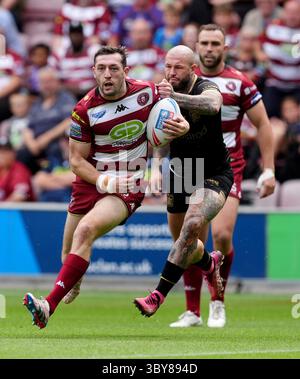 Wigan Warriors' Jake Wardle is tackled by Catalans Dragons' Ugo Tison ...