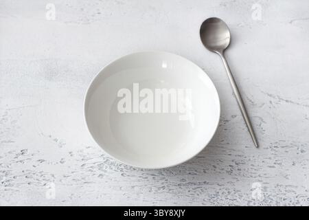 Stylish stainless steel fork on white wooden background Stock Photo - Alamy