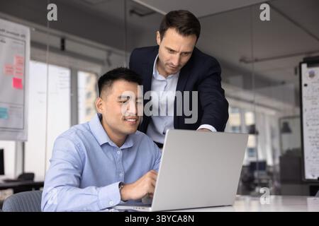 Asian business team collaborating on UI UX design creative process in ...