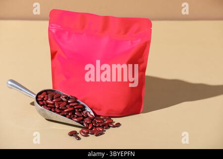 Zipper stand-up pouch and dry kidney beans on beige background, mockup ...