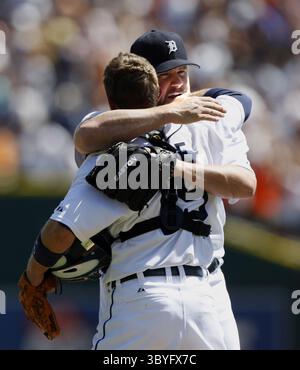 Detroit Tigers' Brandon Inge, right, scores as Oakland Athletics ...