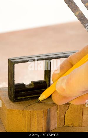 Quality control. Carpenter with spirit level checking the level of ...