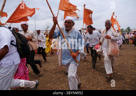 Devotees participate in the vibrant Wari Palki Yatra at Pandharpur, a ...