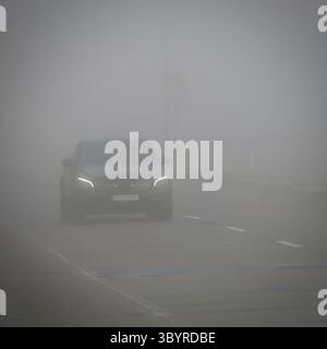 Bad weather driving - foggy hazy country road. Motorway - road traffic ...