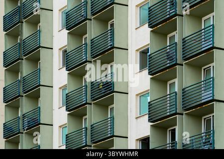 Old-style tower block with repeated green balconies and contrasting ...