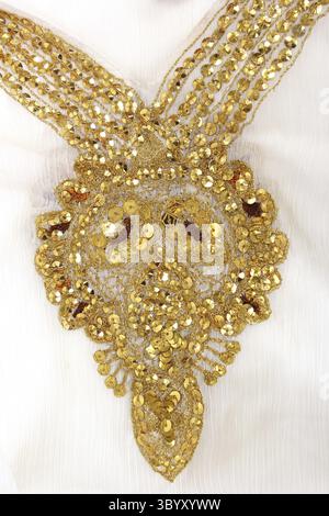 Gold Sequins on White Fabric Close up Stock Photo - Alamy
