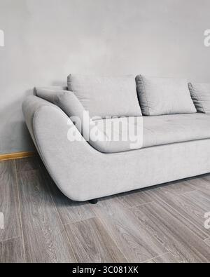 Interior of light living room with grey sofa, fireplace, coffee table ...