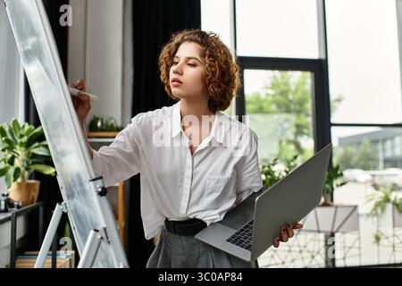 Its all about dynamic ideas. a young businesswoman writing notes on a ...