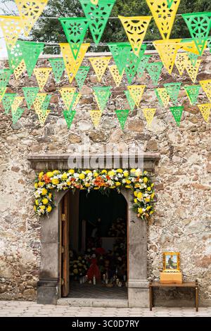 Colorful papel picado fiesta banners and Mexican flags decorate a ...