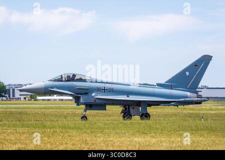 An air-to-air left side view of a multinational variable-swept-winged ...