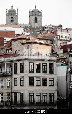 A city scape of Porto depicts typical red roofed houses and the Se do ...