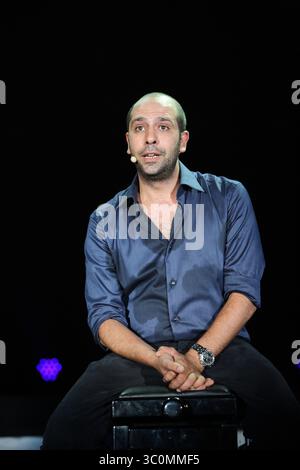 Luca Medici, alias Checco Zalone, on stage with a group of Brazilian ...