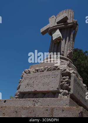 Granite sculpture of a cross tied to a truncated column on a tomb at ...
