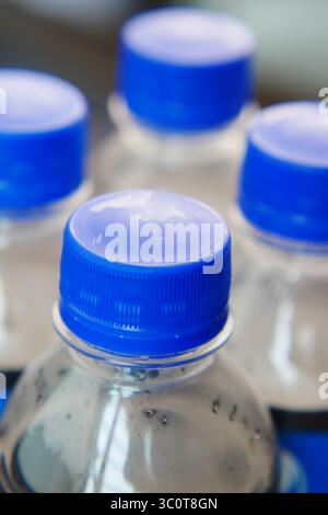 water bottles with blue caps in supermarket Stock Photo - Alamy