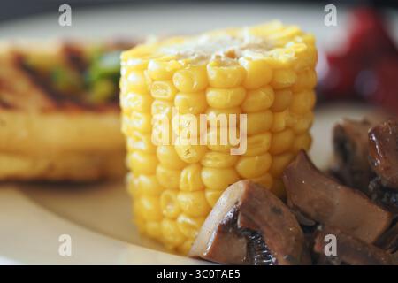 Delicious corn dish served on a spoon with creamy sauce Stock Photo - Alamy