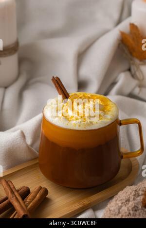 Pumpkin spice latte concept. Decorative pumpkin and cones next to hot ...
